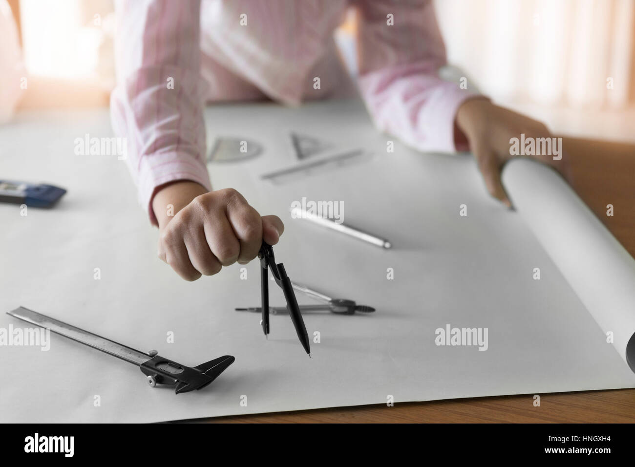 architect hand holding compass working on construction engineering ...