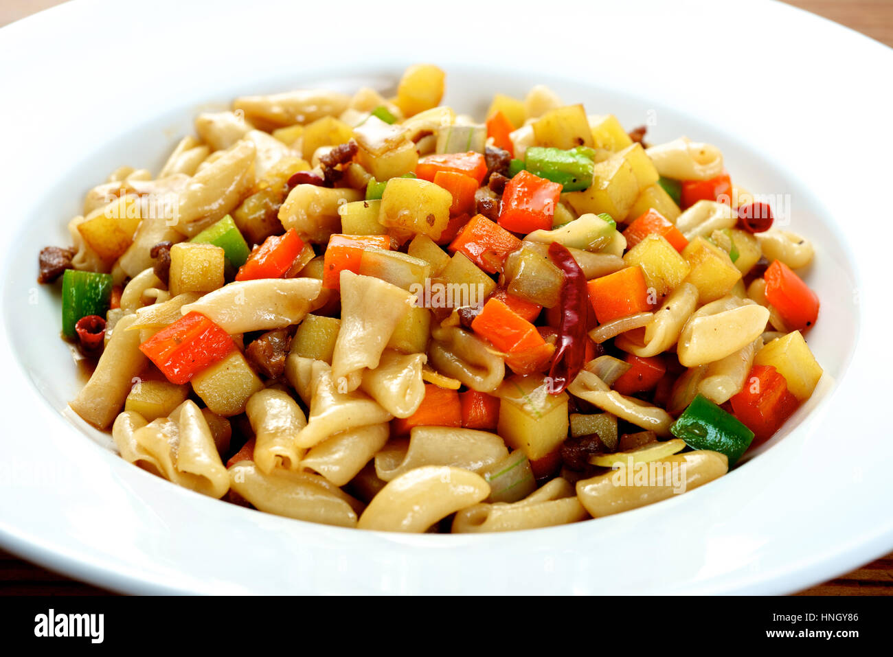 Colorful Chinese Pasta Dish on a white plate Stock Photo - Alamy