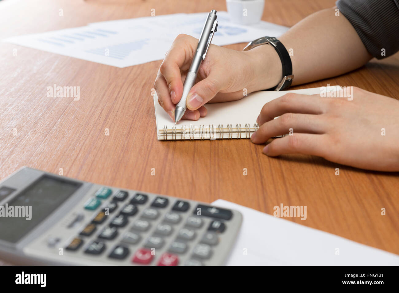 businessman writing note on notepad on office desk Stock Photo - Alamy