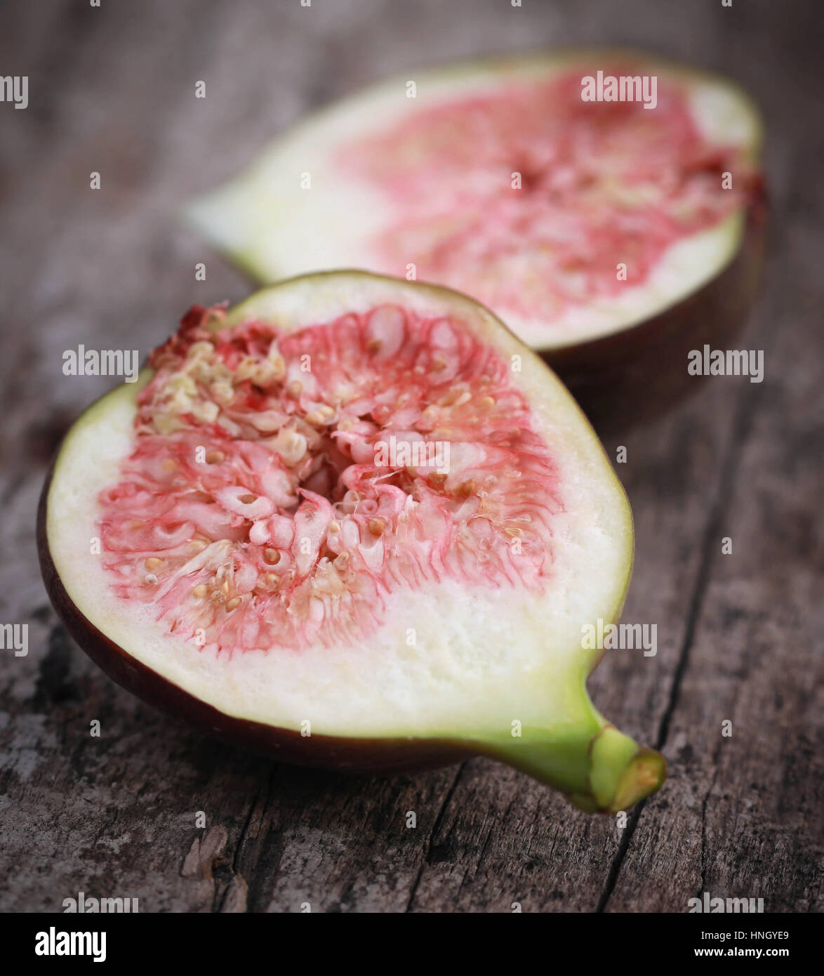 Fresh organic common fig sliced on wooden surface Stock Photo - Alamy