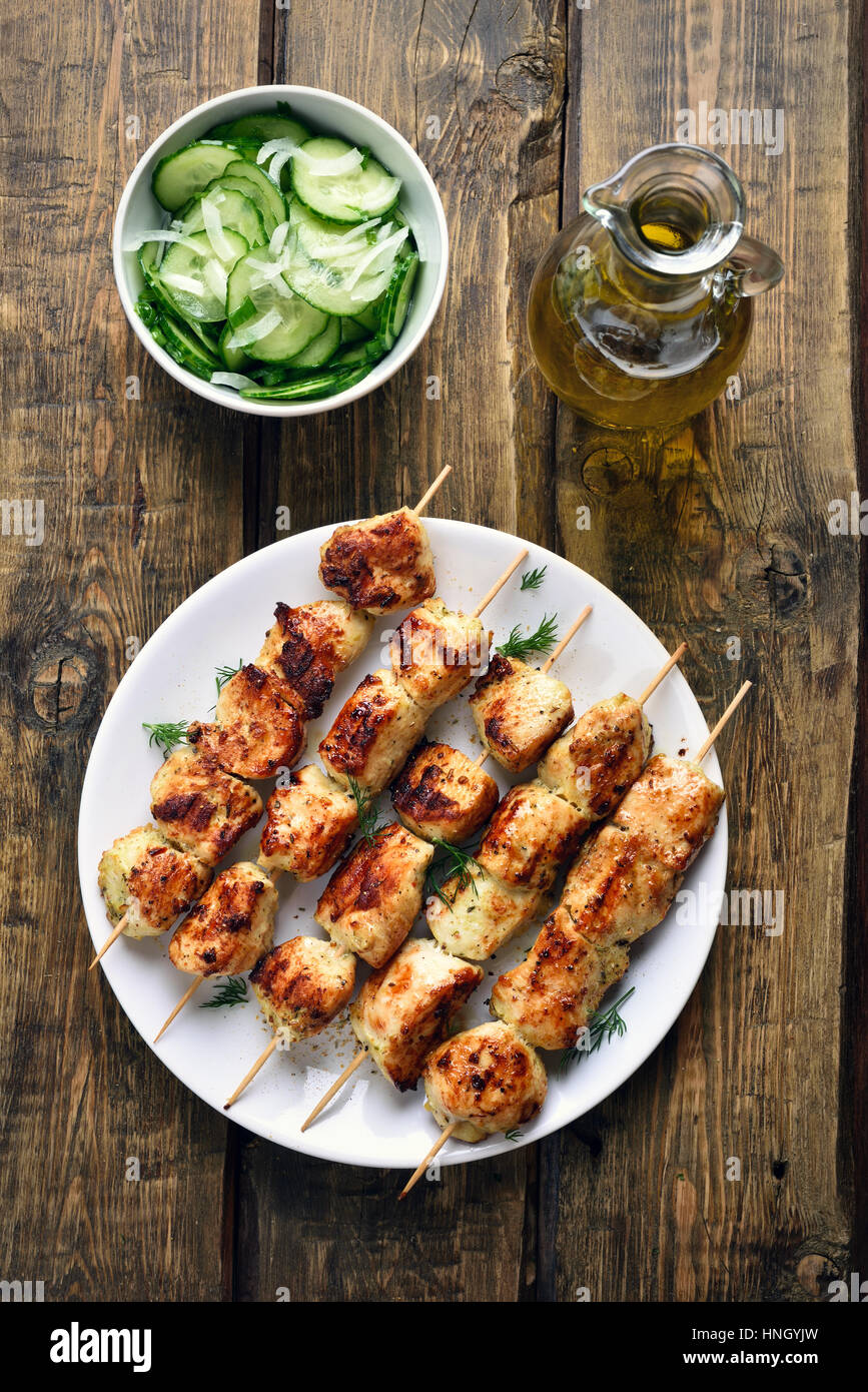 Chicken kebab and cucumber salad, country style, top view Stock Photo ...