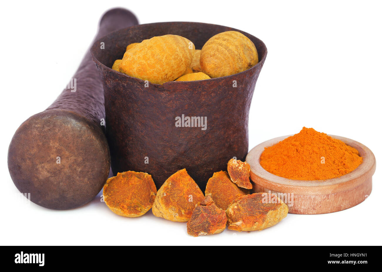 Whole and ground turmeric in bowl with mortar and pestle Stock Photo ...