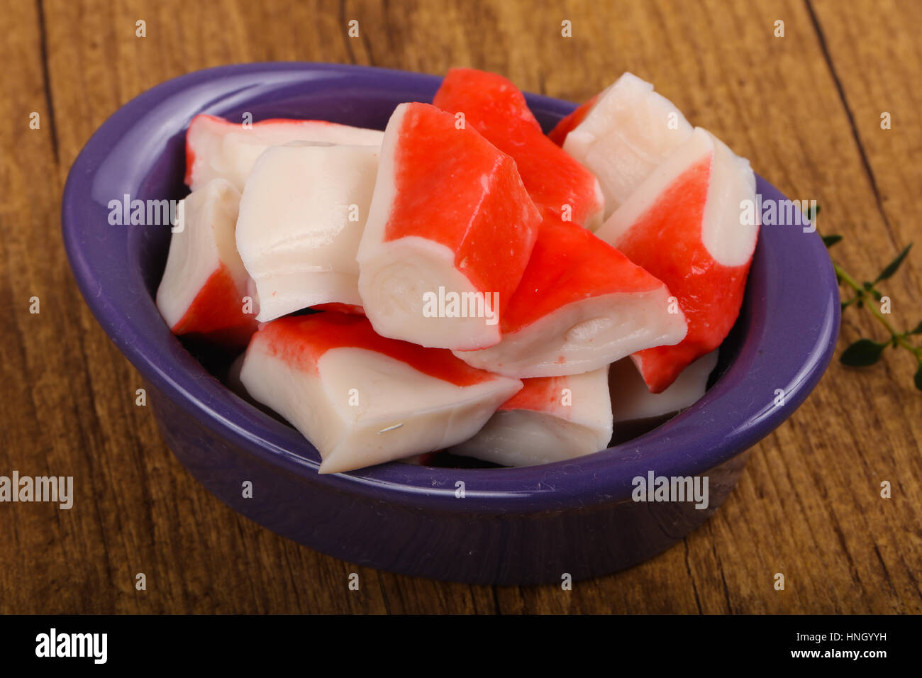 Crab stick - surimi in the plate - over wood background Stock Photo - Alamy