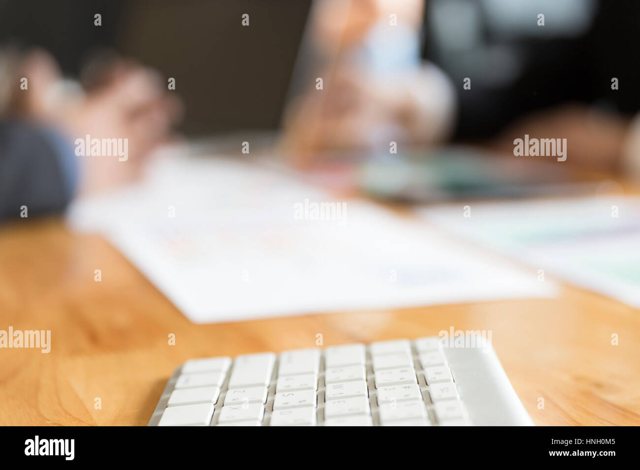 keyboard computer with background of businessman meeting, analyzing and ...