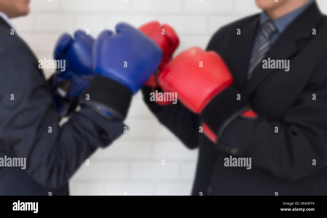 businessman in necktie and suit with red and blue boxing gloves ...