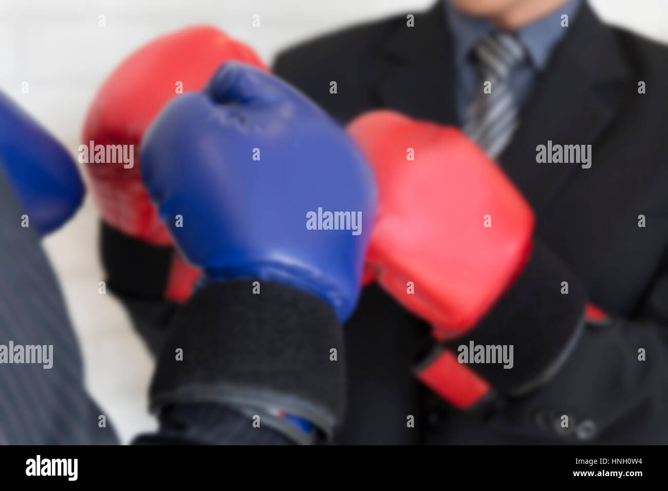 businessman in necktie and suit with red and blue boxing gloves ...