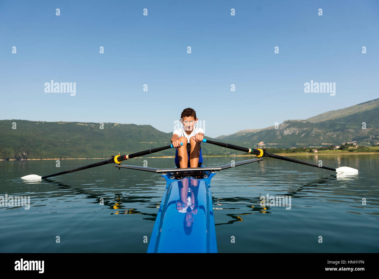 The young sportsman is rowing on the racing kayak Stock Photo - Alamy