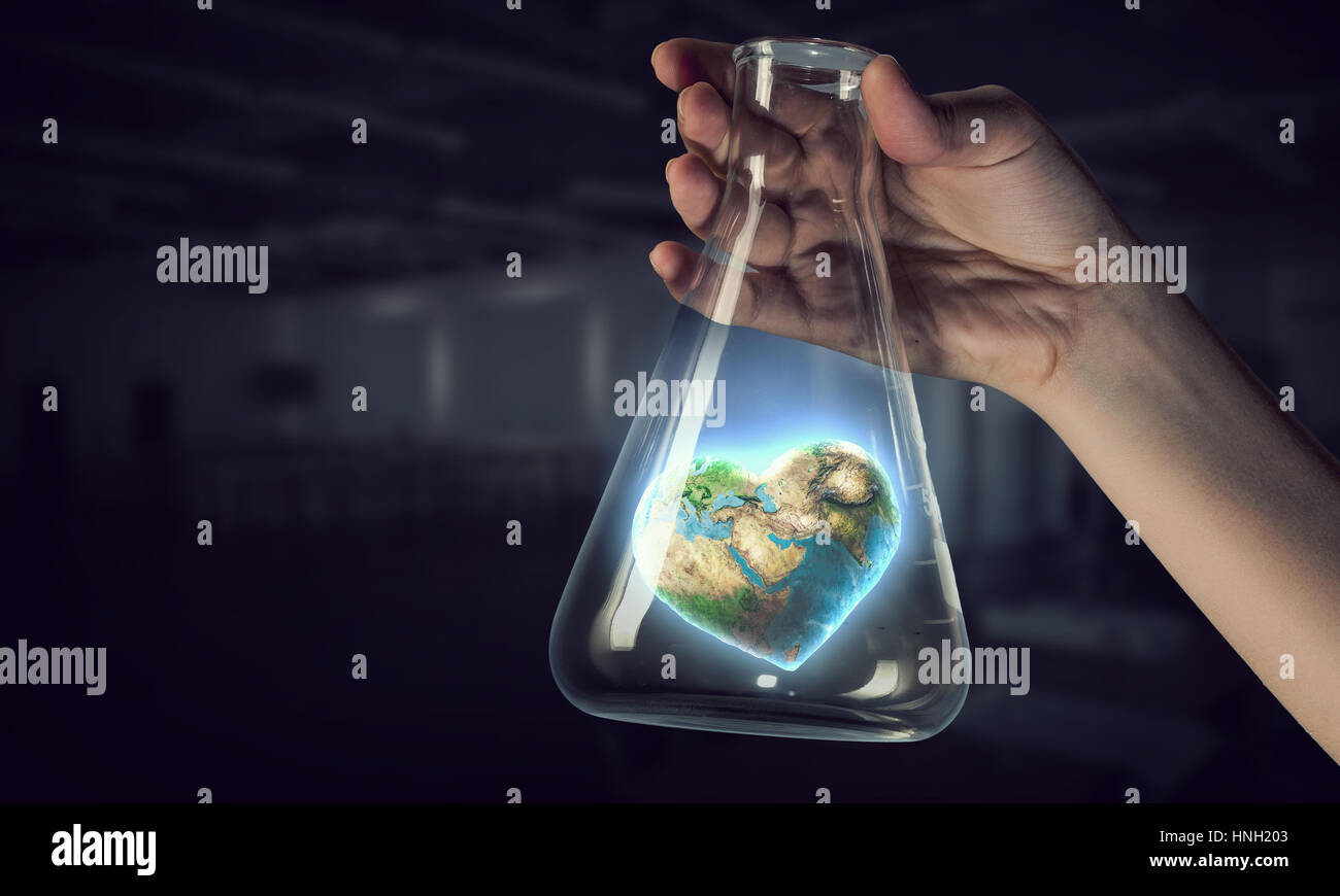 Close up of human hand holding test tube with Earth planet. Elements of ...