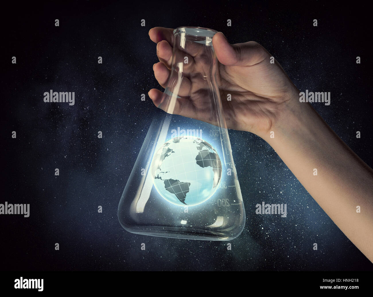 Close up of human hand holding test tube with digital planet Stock ...