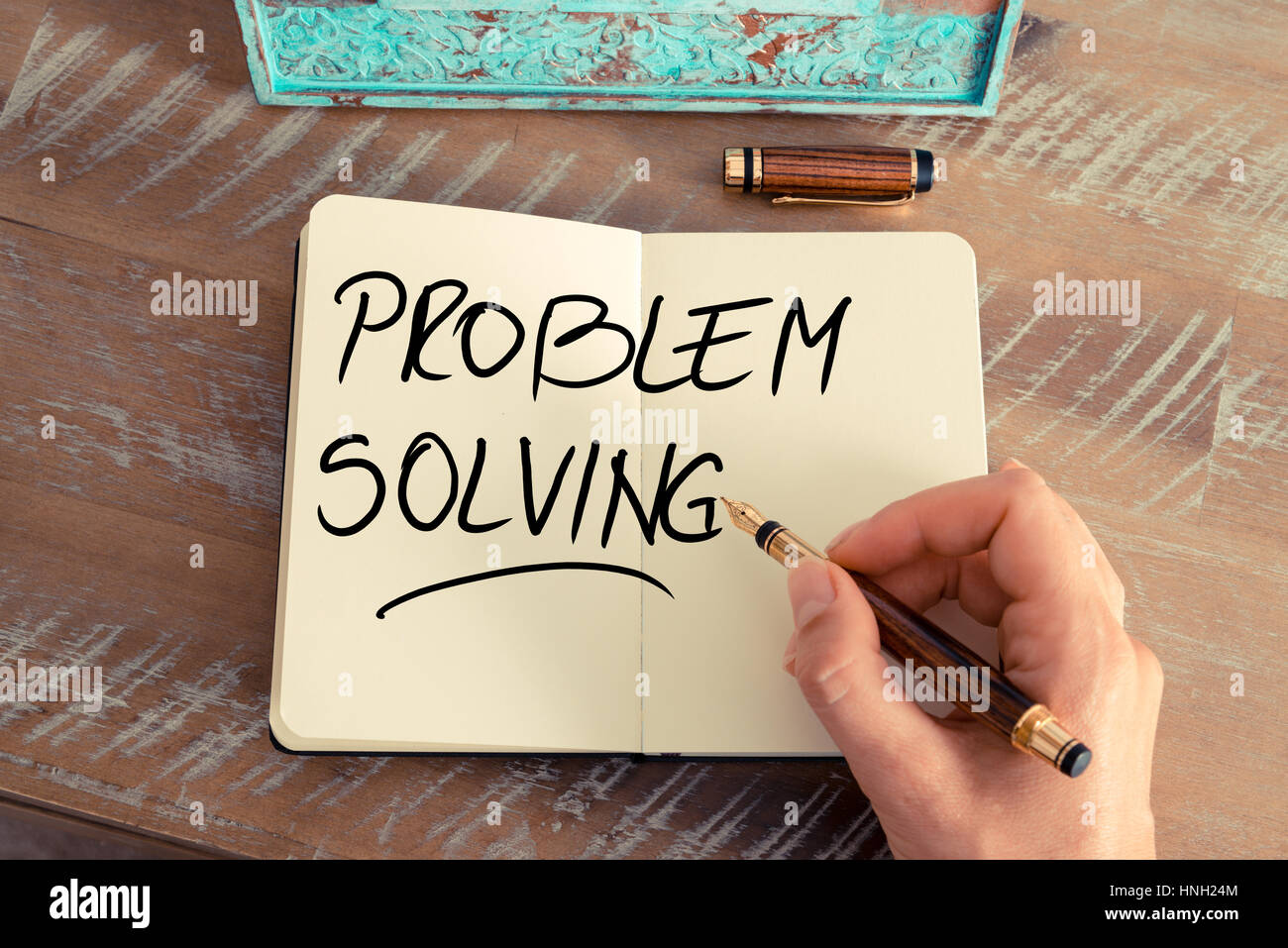 Retro effect and toned image of a woman hand writing a note with a ...