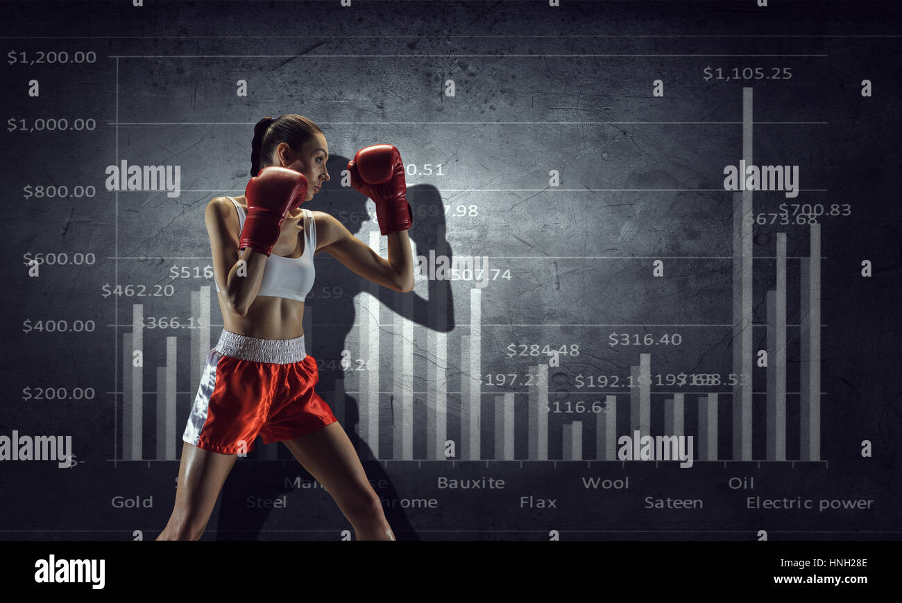 Young woman boxing against graphs background. Mixed media Stock Photo ...