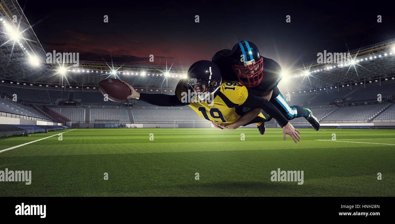 Two american football players fighting for ball. Mixed media Stock ...