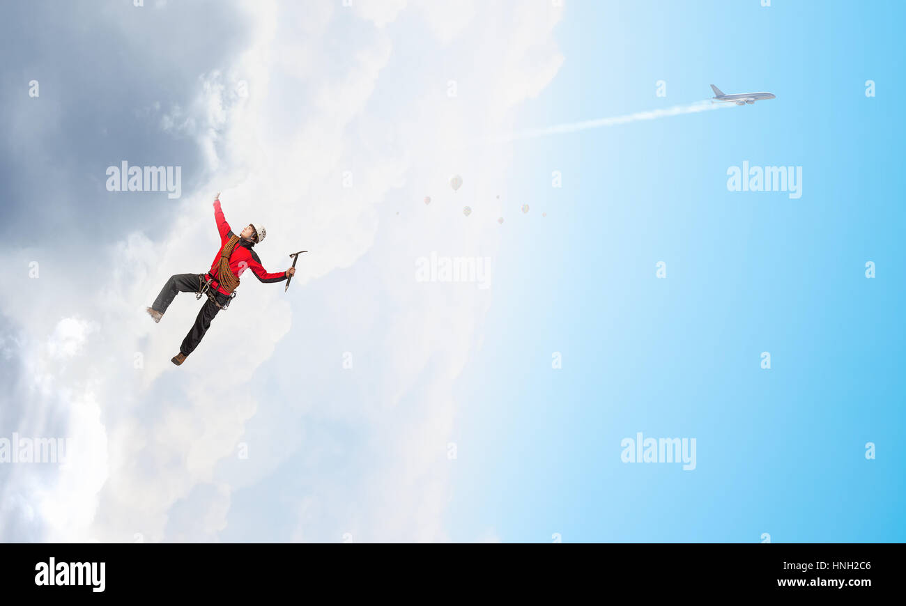 Young brave man alpinist climbing on cloud high in sky Stock Photo - Alamy