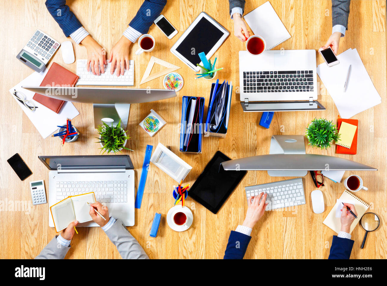 Top view of office table with four colleagues working together Stock ...