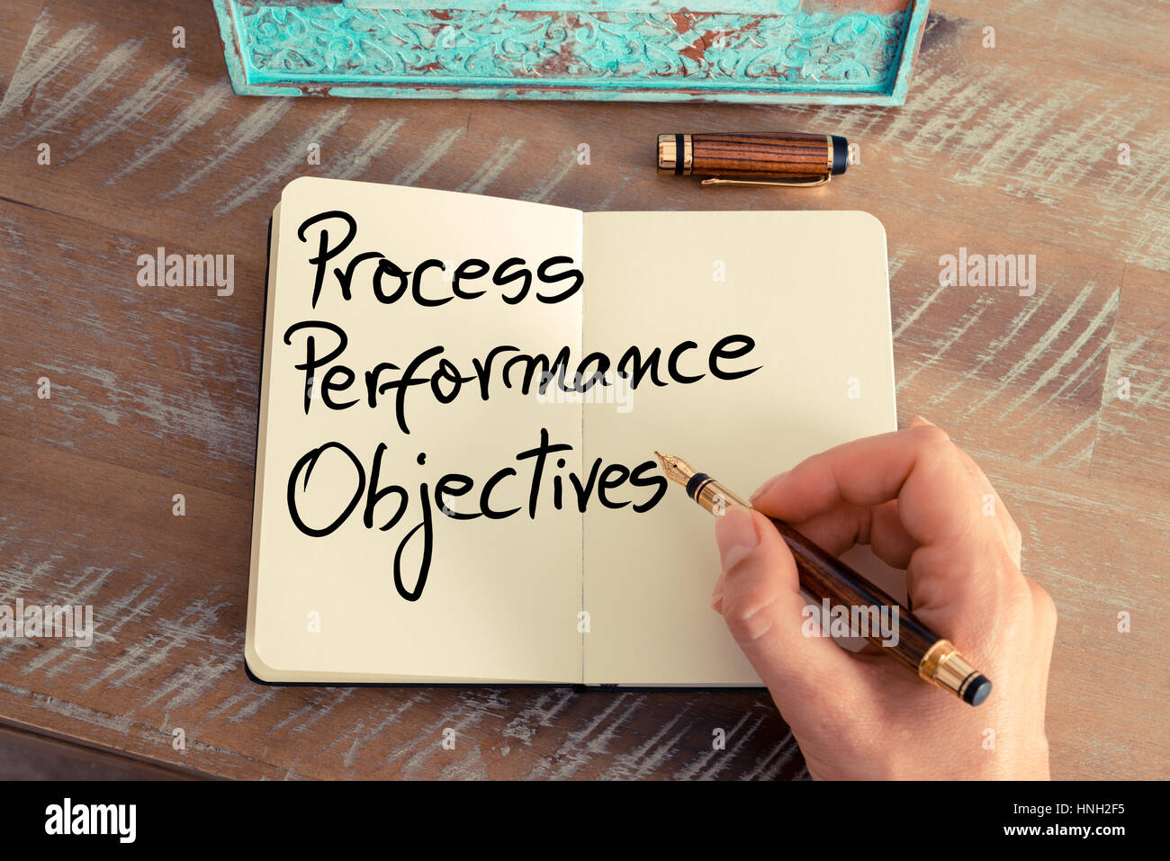 Retro effect and toned image of a woman hand writing a note with a ...