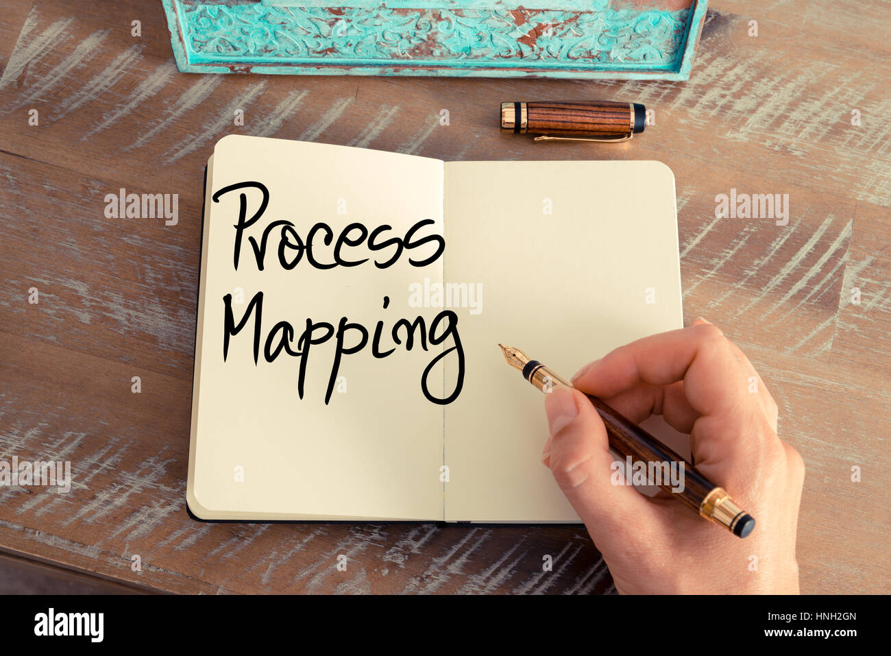 Retro effect and toned image of a woman hand writing a note with a ...