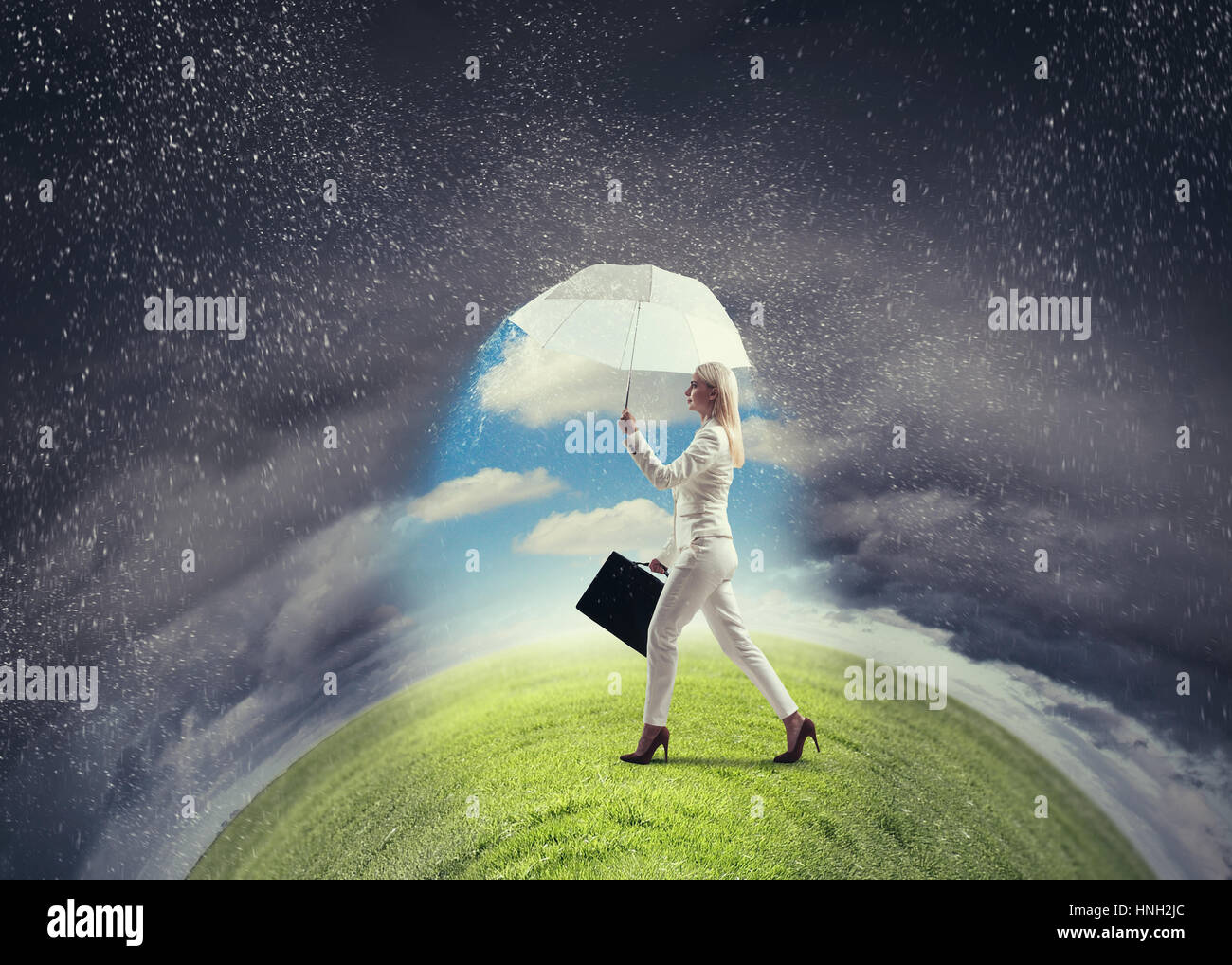 Elegant businesswoman hiding from rain under umbrella Stock Photo - Alamy