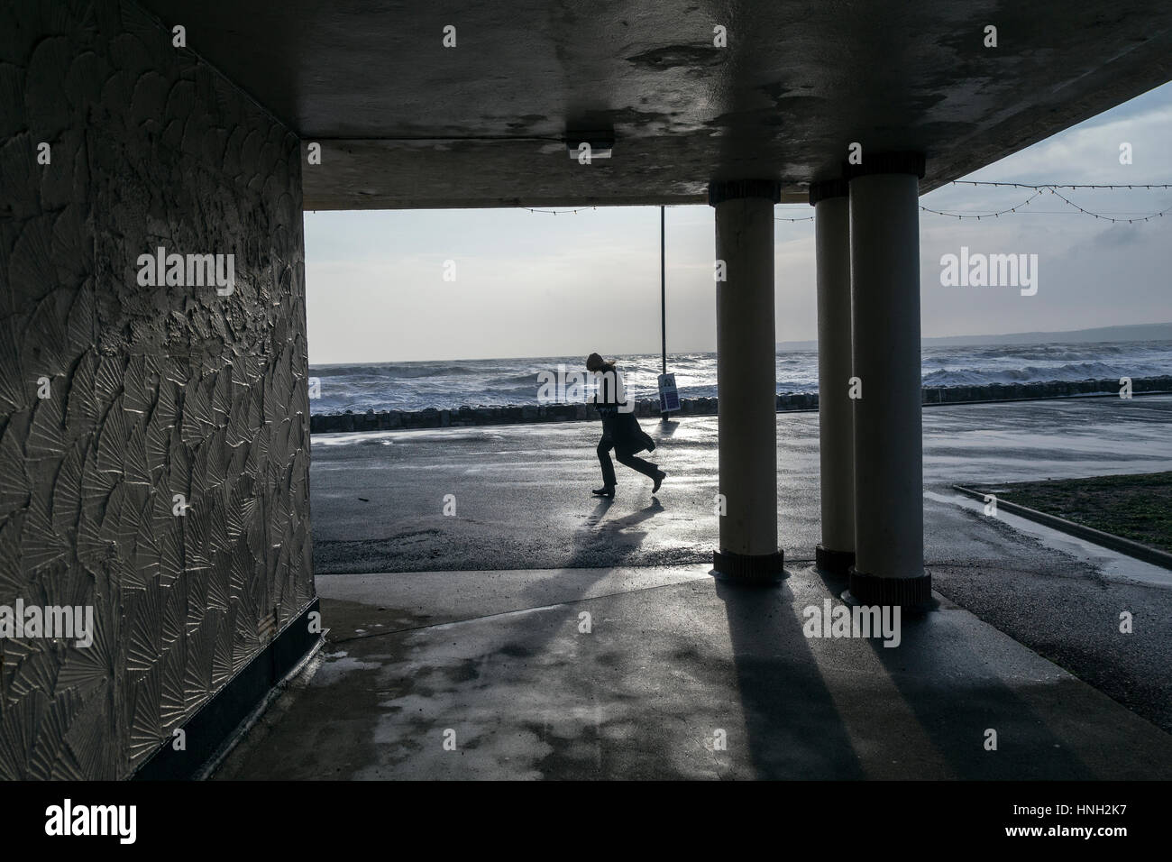women runs from winter storms in Paignton South Devon,path, pathway ...