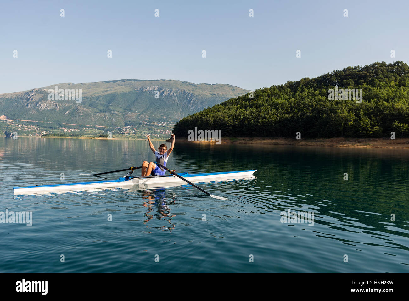 The young sportsman is rowing on the racing kayak Stock Photo - Alamy