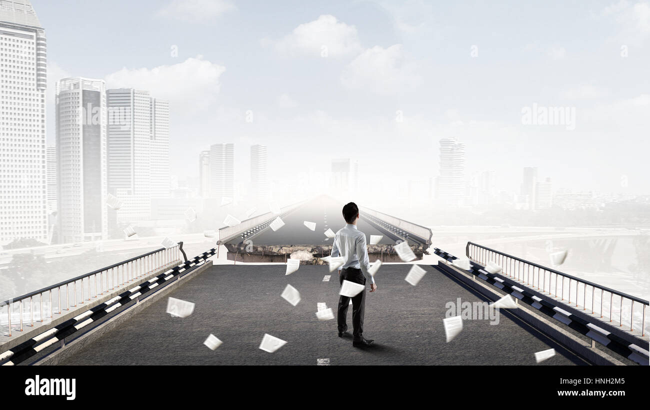 Businessman standing on edge of destructed bridge. Mixed media Stock ...