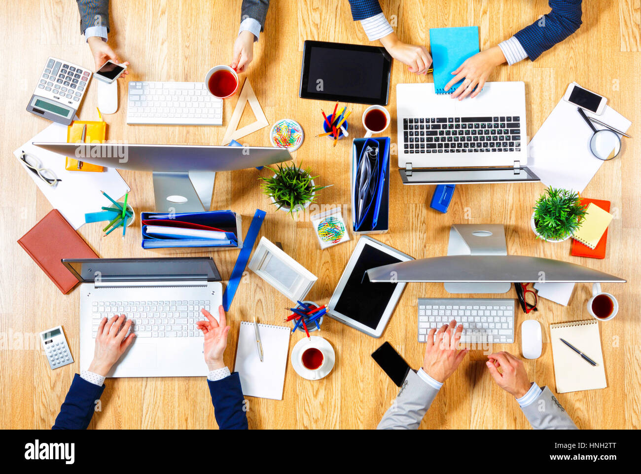 Top view of office table with four colleagues working together Stock ...