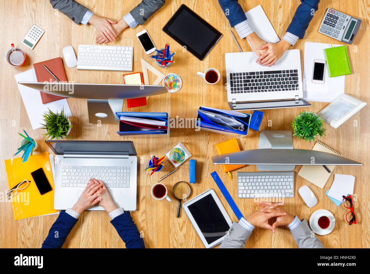 Top view of office table with four colleagues working together Stock ...