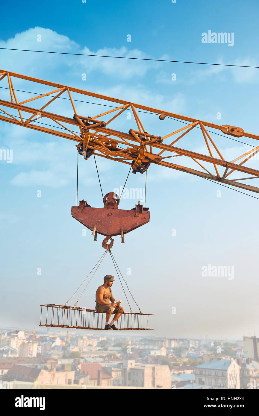 Man sitting on crane hi-res stock photography and images - Alamy