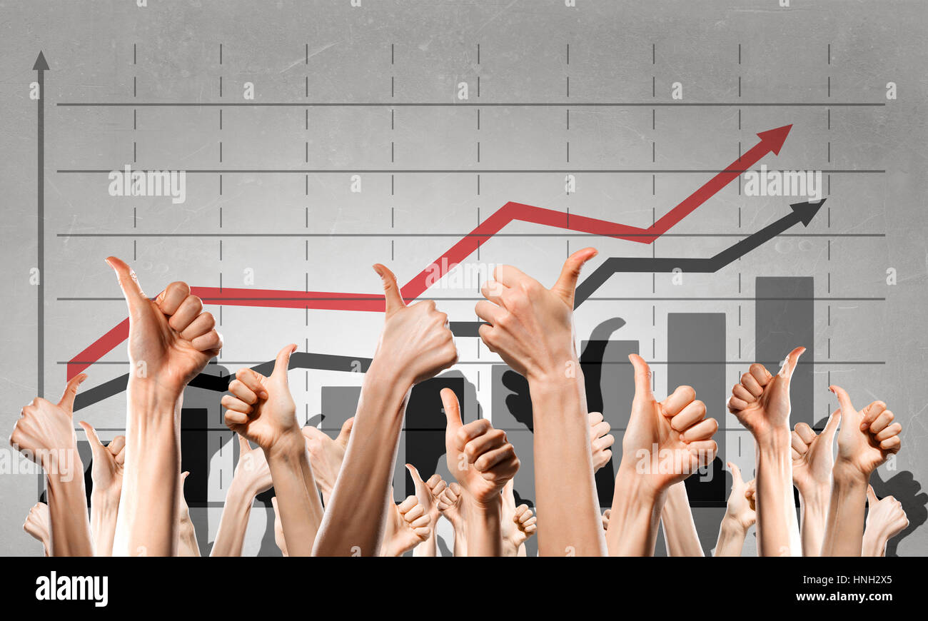 Row of raised hands showing different gestures and graphs at background ...
