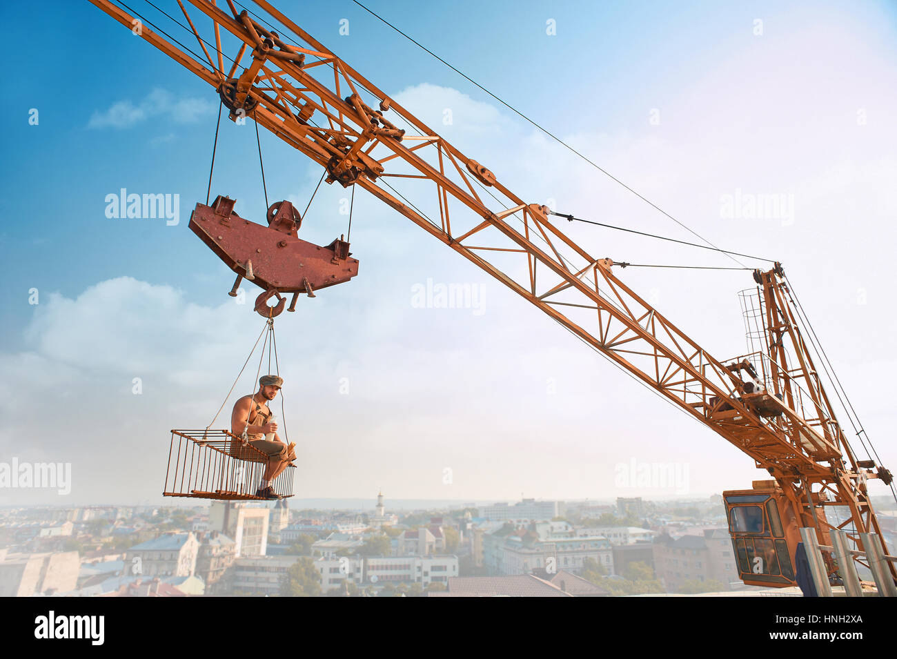 Man sitting on crane hi-res stock photography and images - Alamy