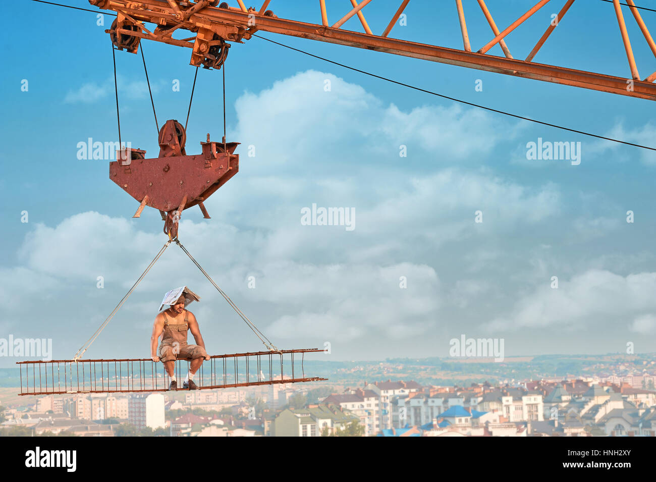 Man sitting on crane hi-res stock photography and images - Alamy