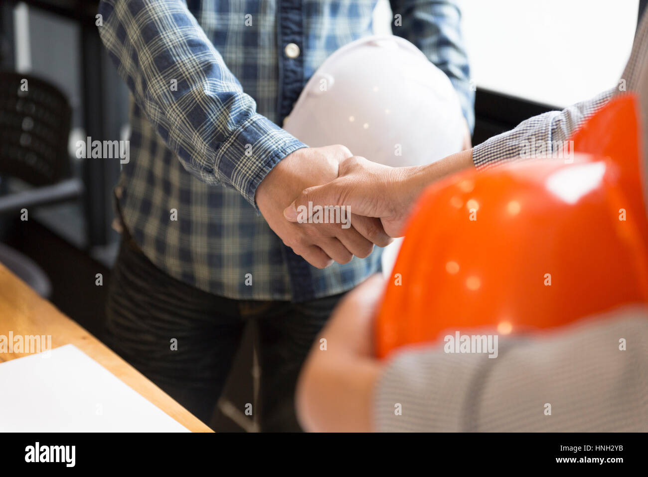architect engineer shaking hands beside window - business teamwork ...