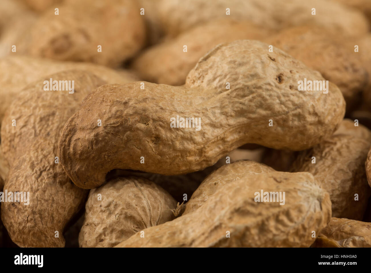 Pile of peanuts shells close up for background Stock Photo - Alamy