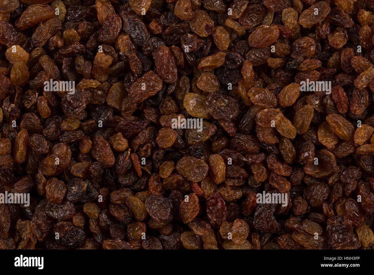 Sweet dry raisins close up shot for background Stock Photo - Alamy