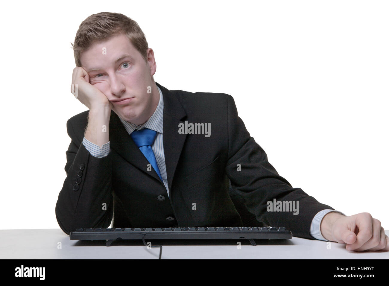 businessman bored at work sitting at his desk Stock Photo - Alamy