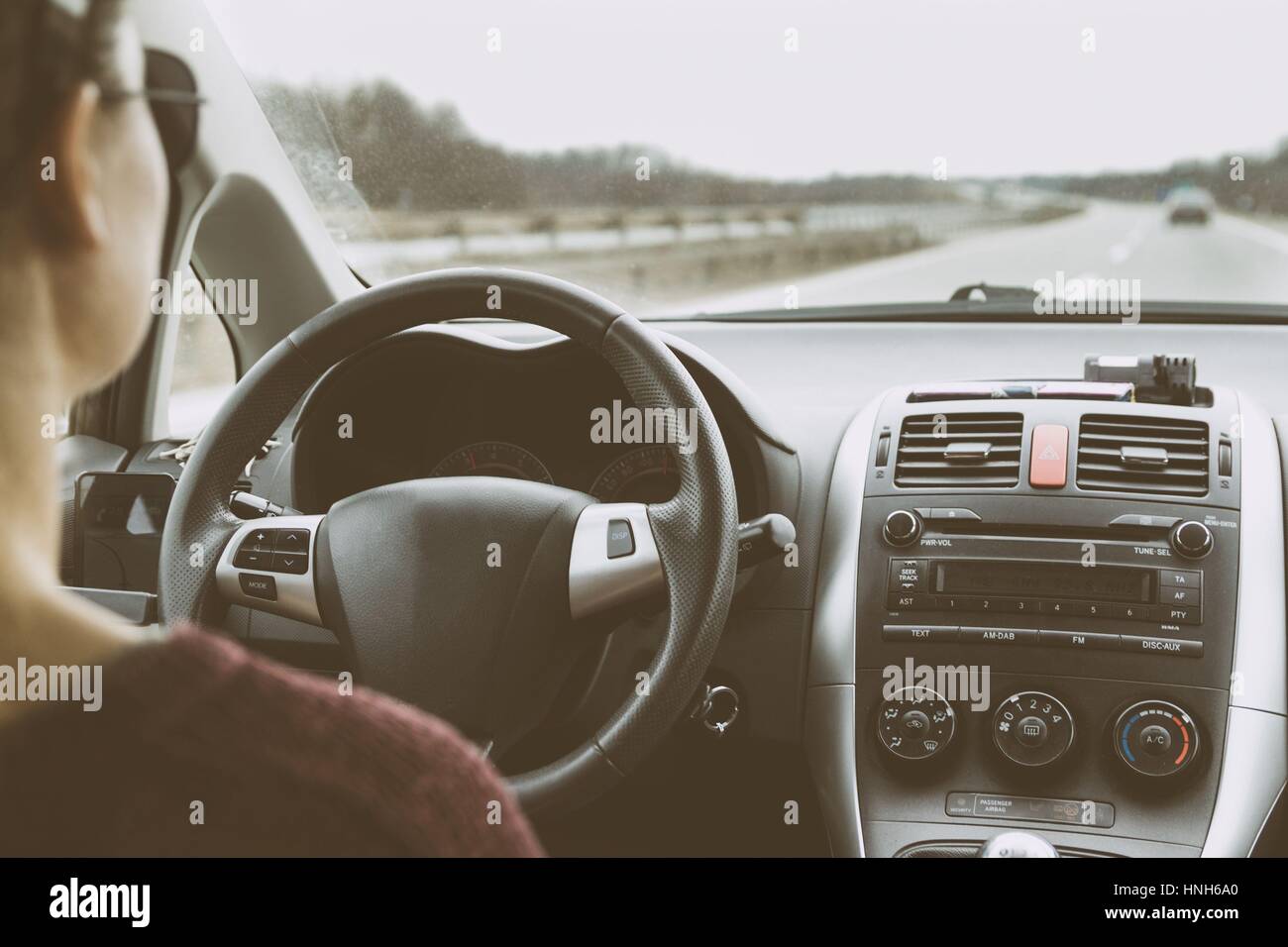 Young woman driving a car on highway Stock Photo - Alamy