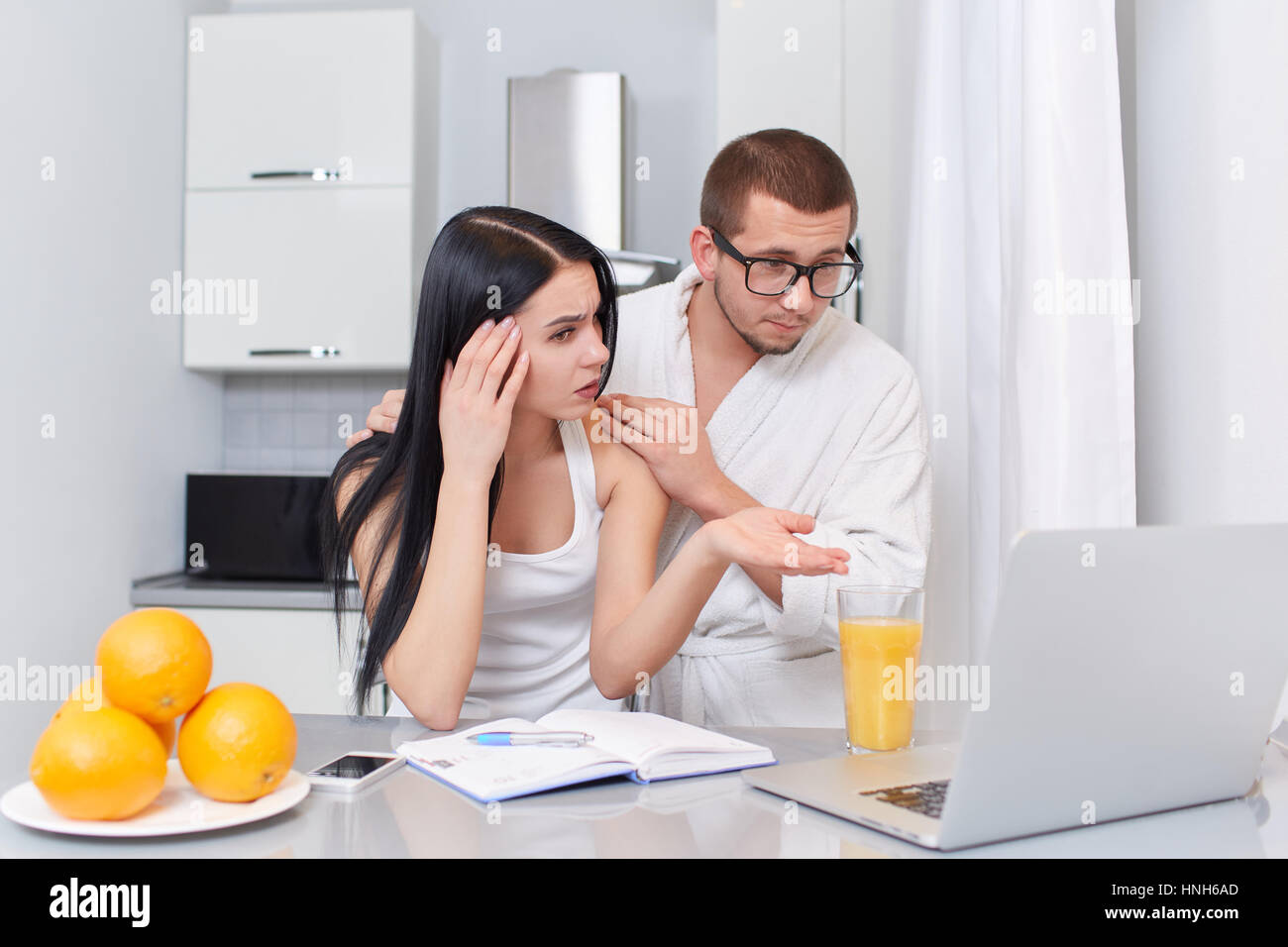 Couple discussing news and watching in laptop Stock Photo - Alamy