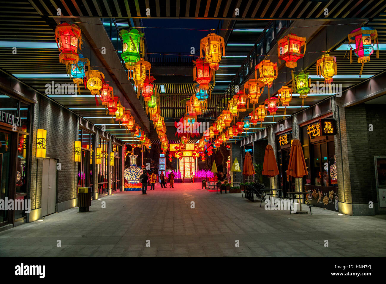 people walking on the street decorated with Chinese traditional ...