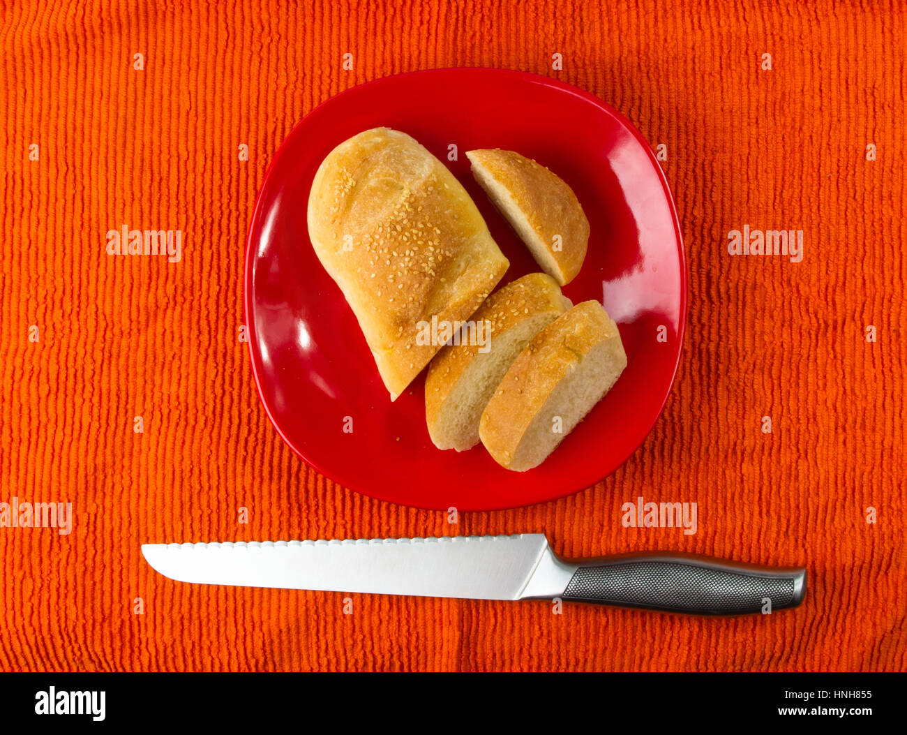 sliced whole wheat breads with a knife on a red plate Stock Photo - Alamy