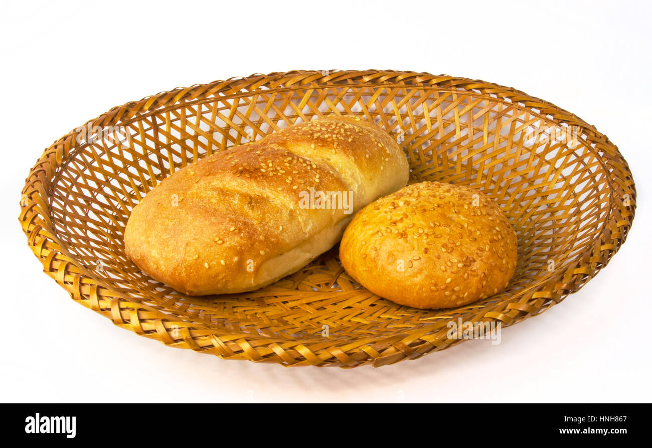 whole wheat bread and bun on a wicker plate Stock Photo - Alamy