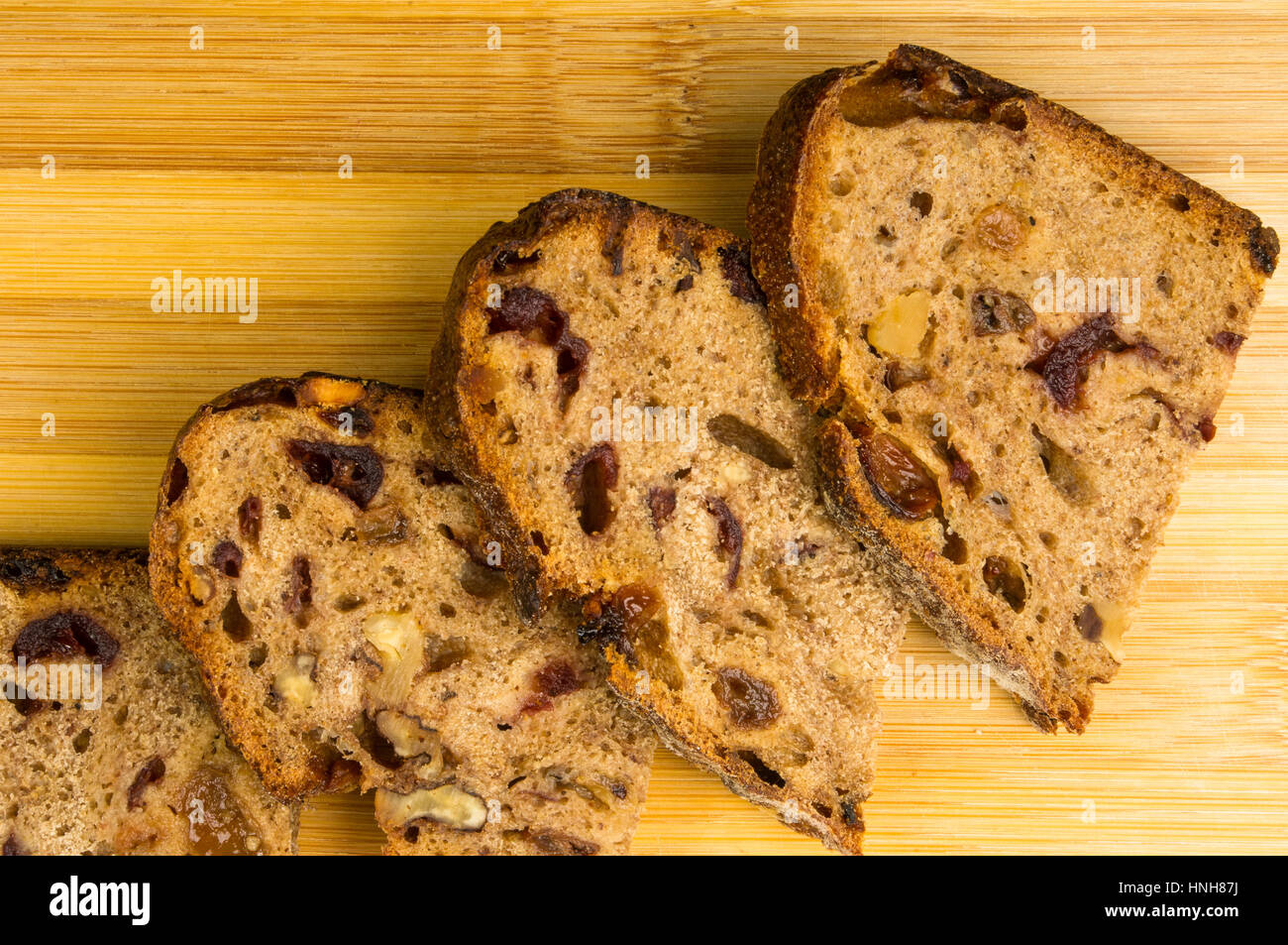 Slices of malt bread handmade with nuts, raisins and cranberries on ...