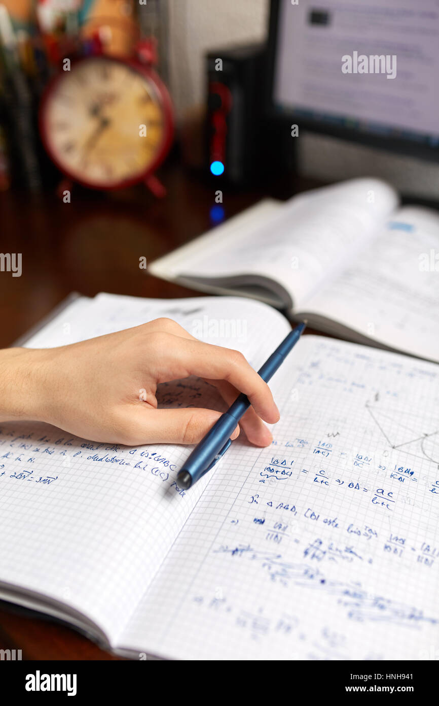 Teenage boy doing homework with the help of computer Stock Photo - Alamy
