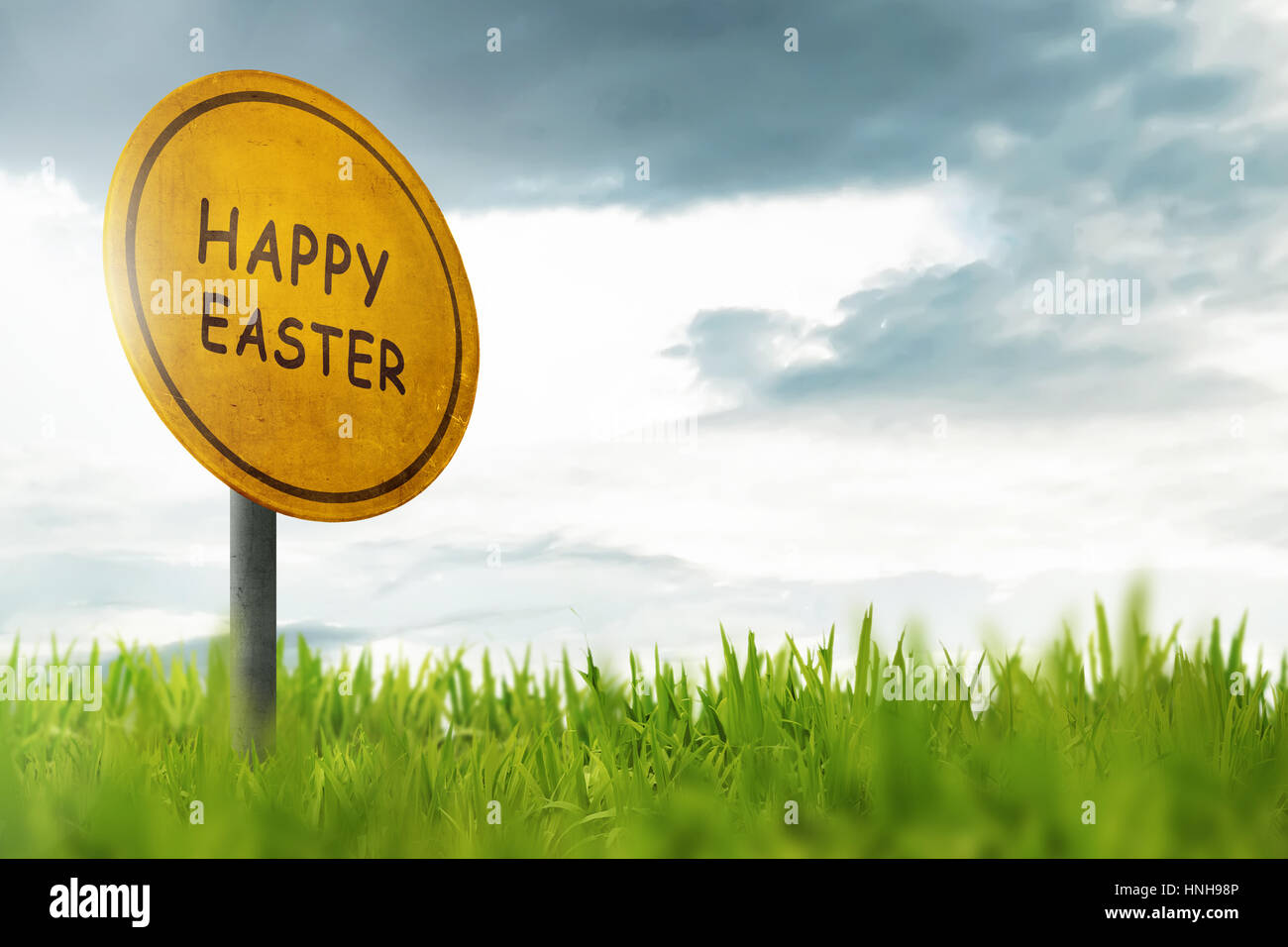 Happy Easter greeting on traffic sign in a grass field with blue sky ...