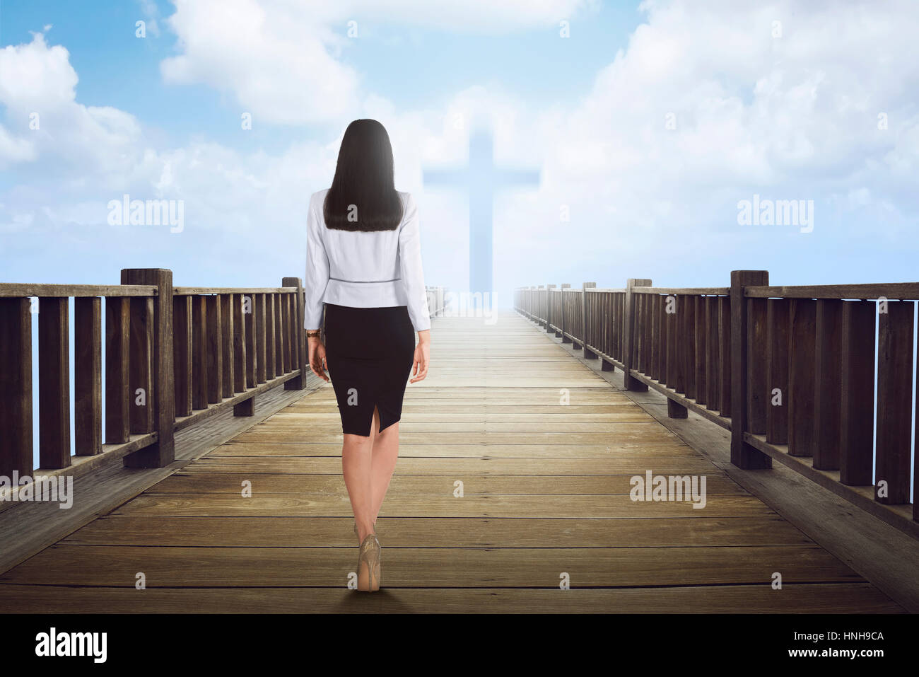 Back view of asian woman walking to cross shape on the cloud Stock ...