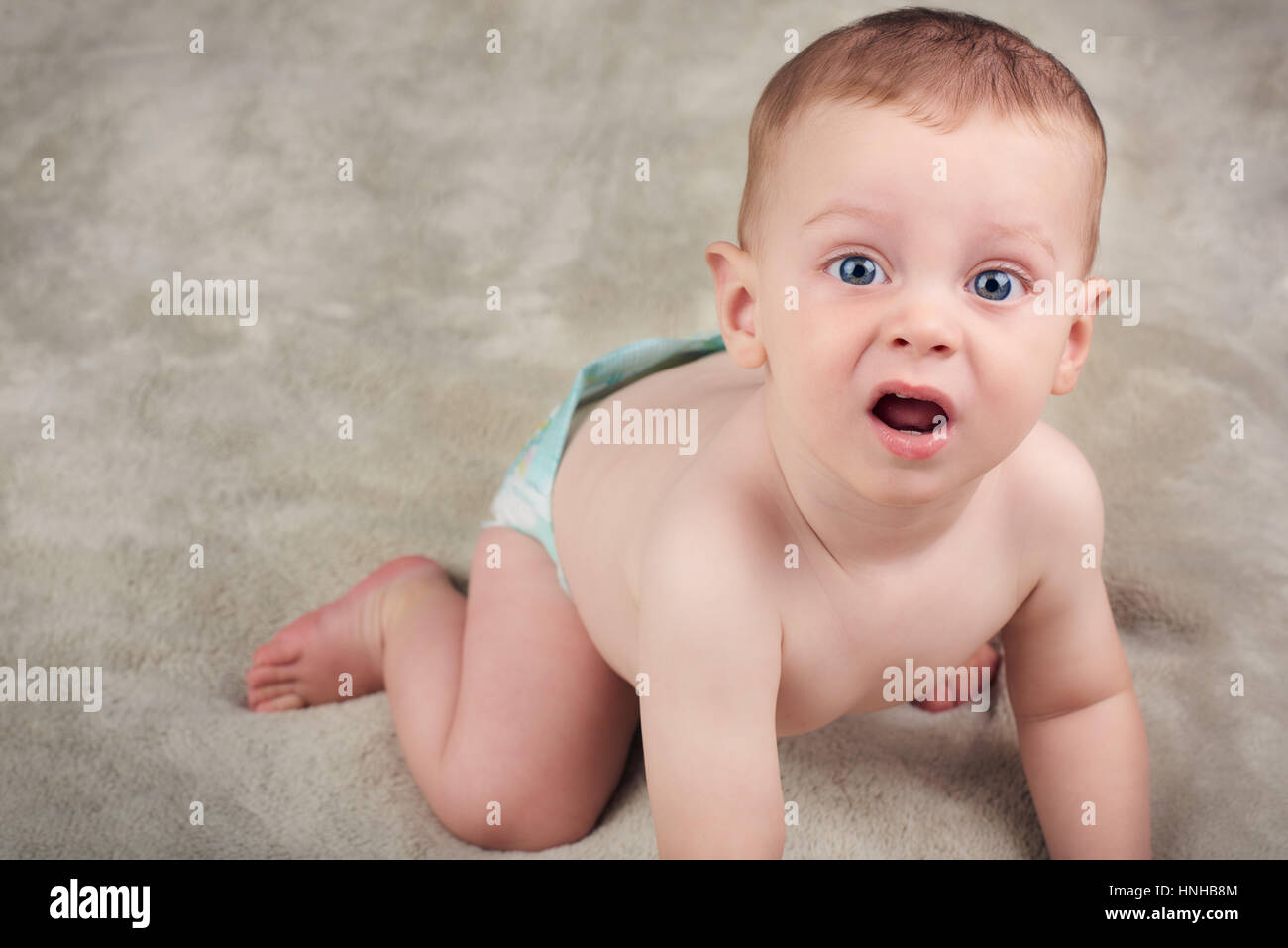 Baby with awkward facial expression looking at camera in nappy Stock ...