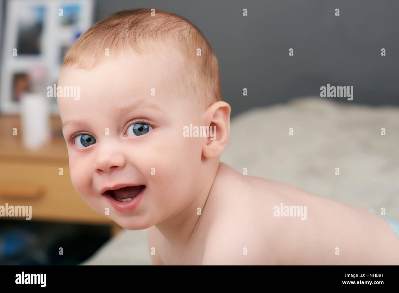 Baby boy with large blue eyes looking into camera Stock Photo - Alamy