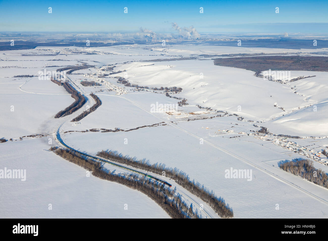Industrial landscape with freight train and chemical factory on ...