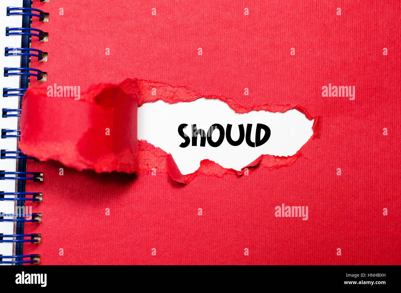 The word should appearing behind torn paper Stock Photo - Alamy