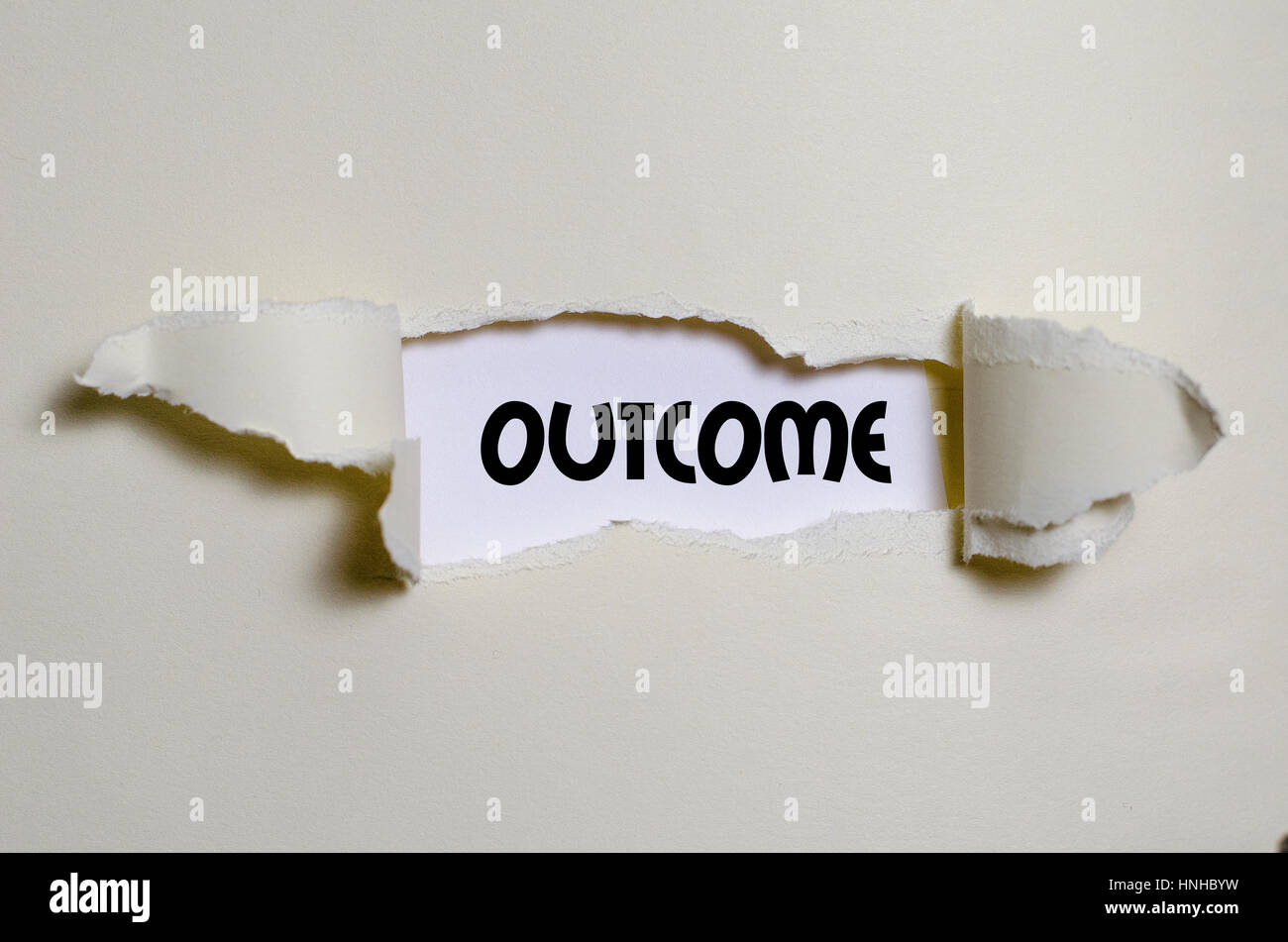 The word outcome appearing behind torn paper Stock Photo - Alamy