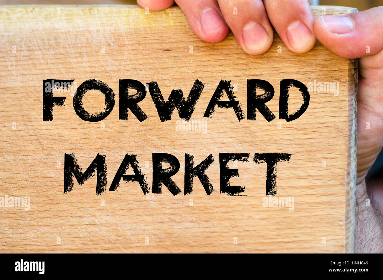 Human hand over wooden background and forward market text concept Stock ...