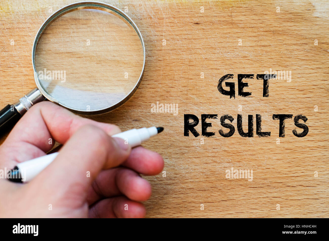 Human hand over wooden background and get results text concept Stock ...